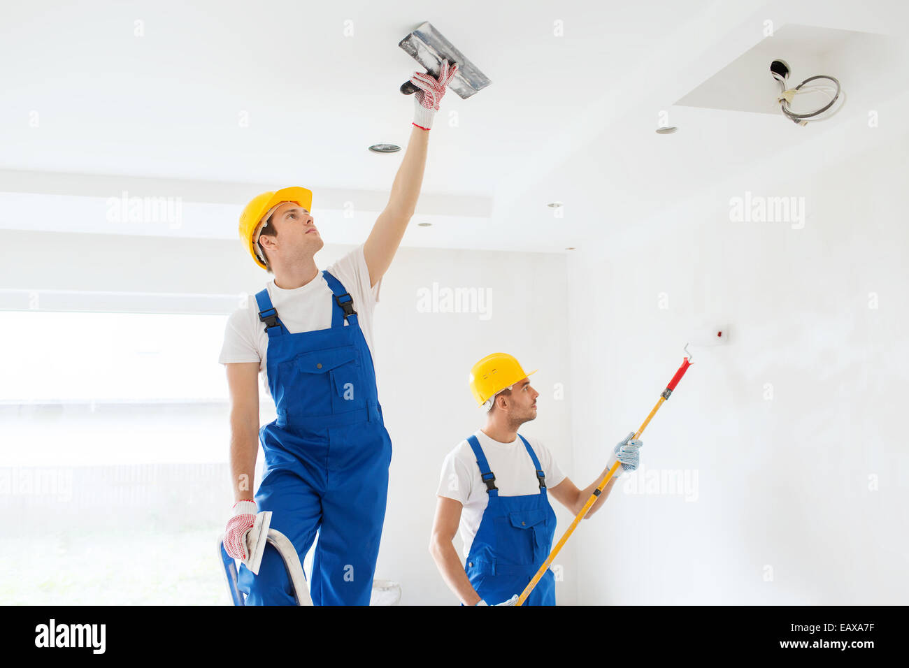 group of builders with tools indoors Stock Photo - Alamy