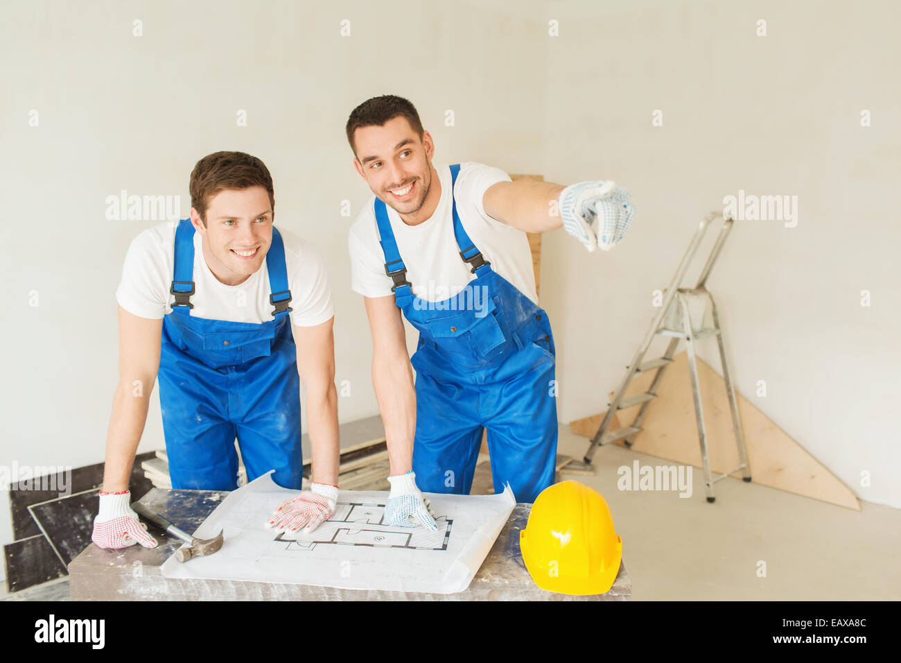 group of builders with blueprint Stock Photo - Alamy