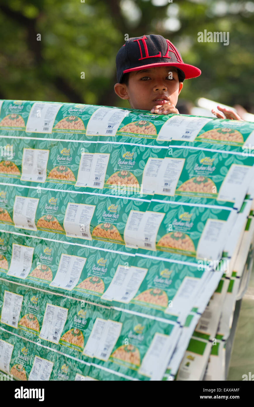 Young Thai boy selling paper sheets at the anti government ...