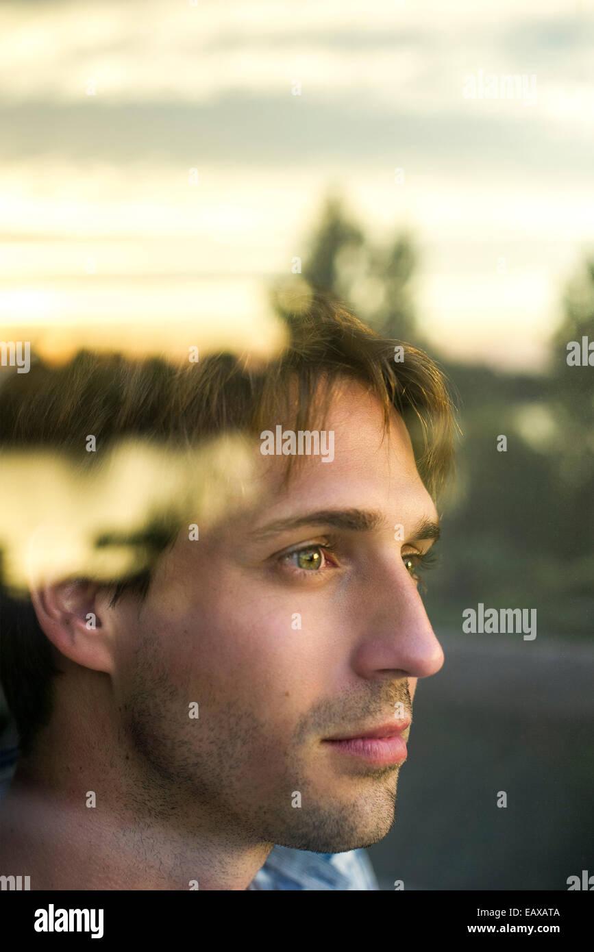 Man looking out window contemplating a future full of potential Stock ...