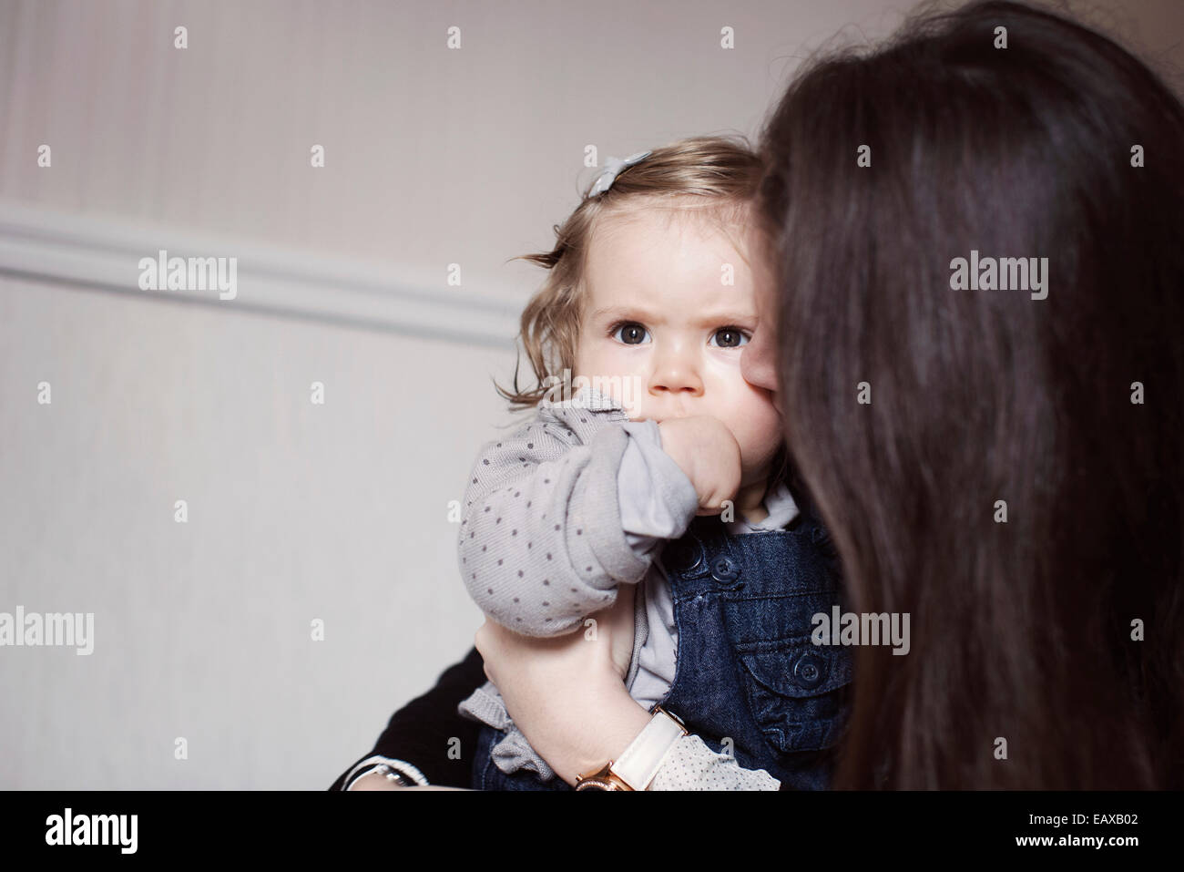 Mother comforting sulky baby girl Stock Photo - Alamy
