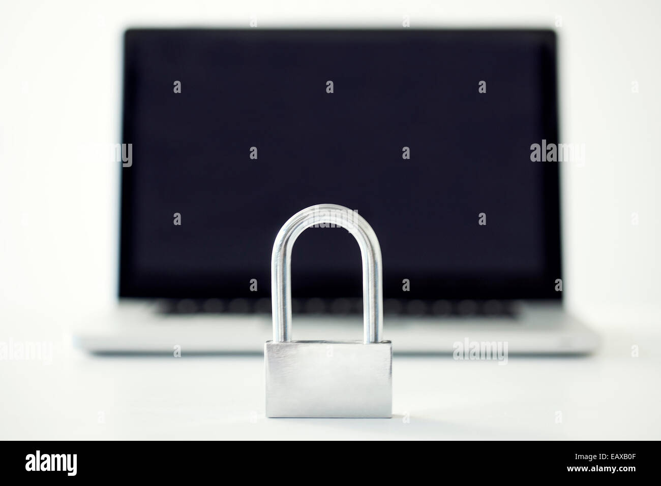 Padlock in front of laptop computer representing internet security ...