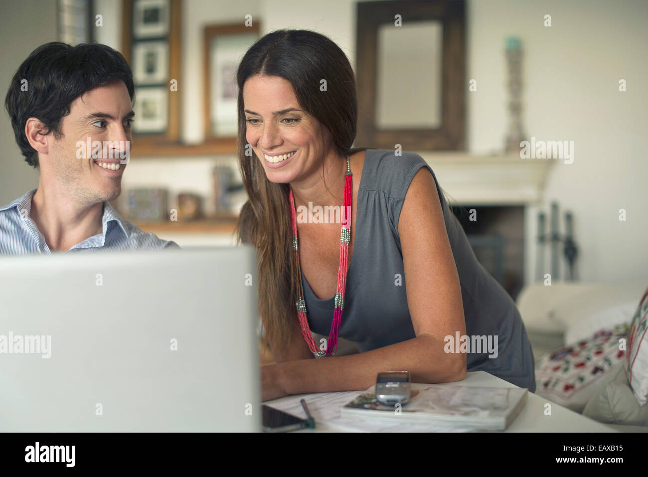 Couple using laptop computer at home Stock Photo - Alamy