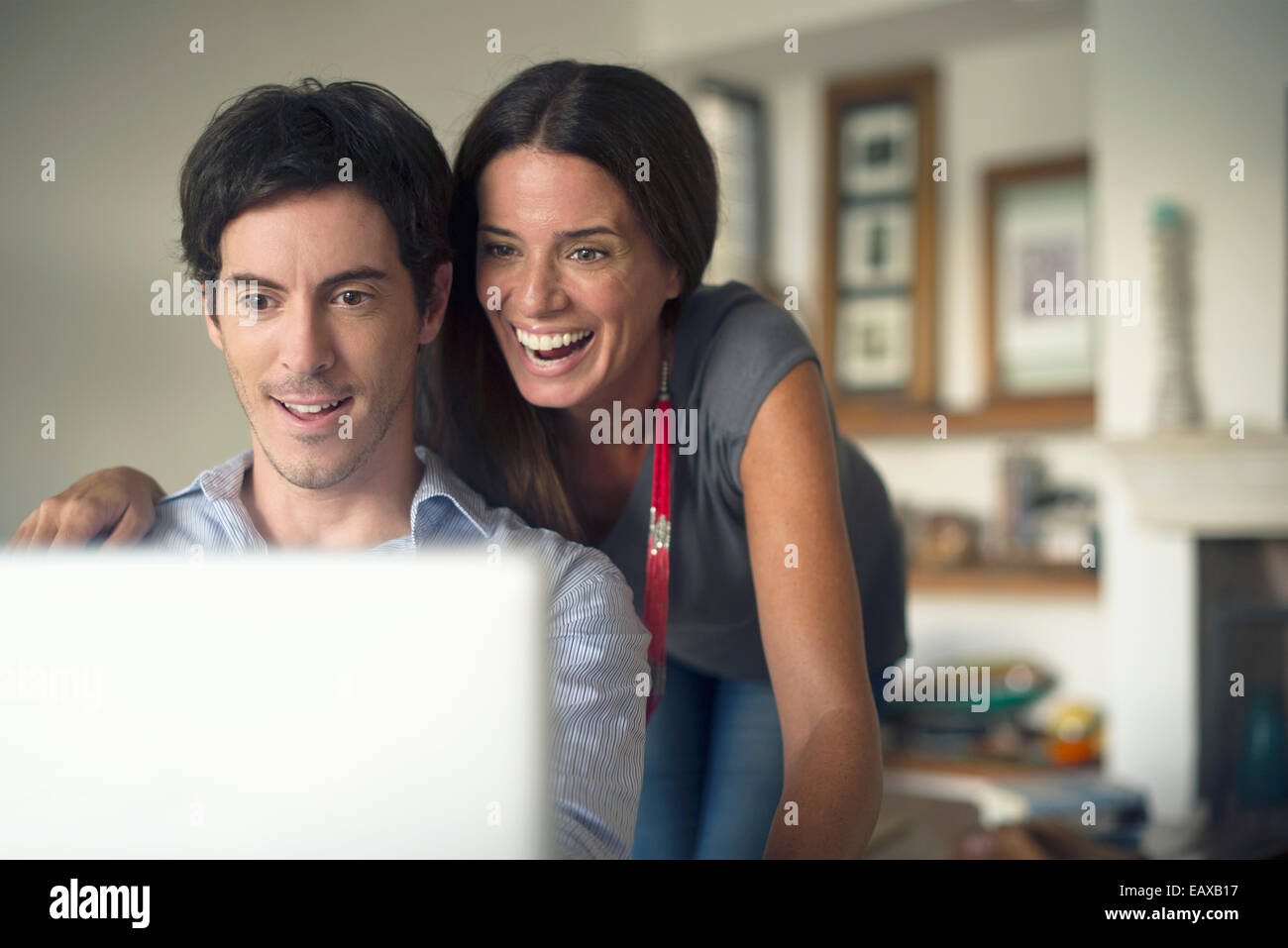 Couple looking at laptop computer together Stock Photo - Alamy