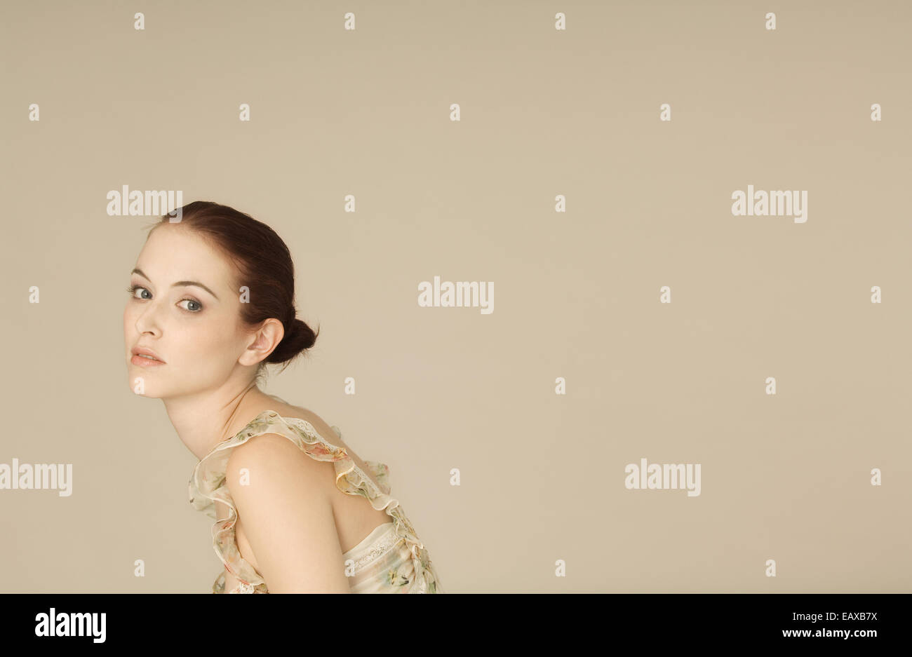 Young woman looking over shoulder sadly, portrait Stock Photo - Alamy