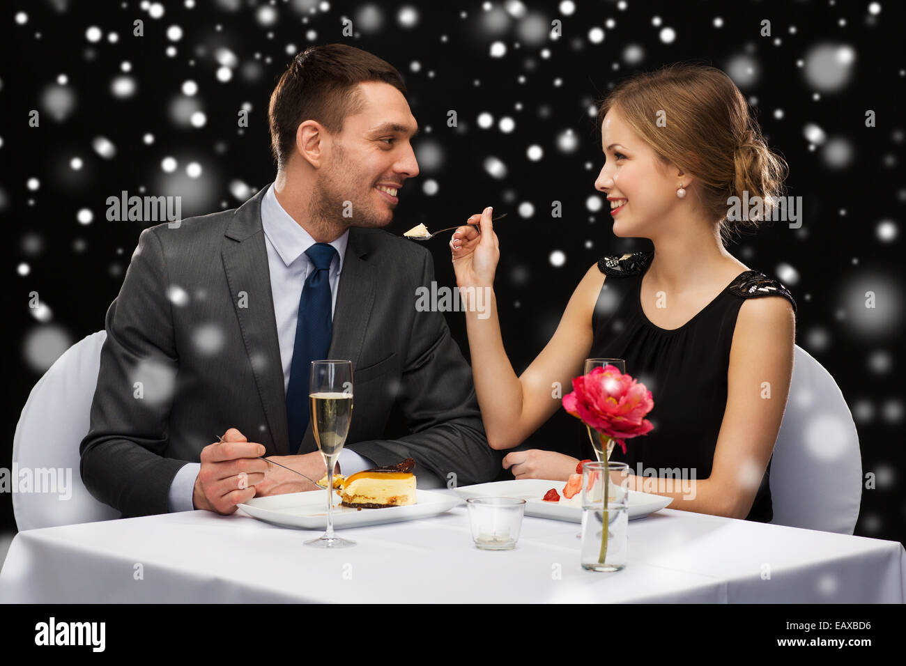 smiling couple eating dessert at restaurant Stock Photo - Alamy