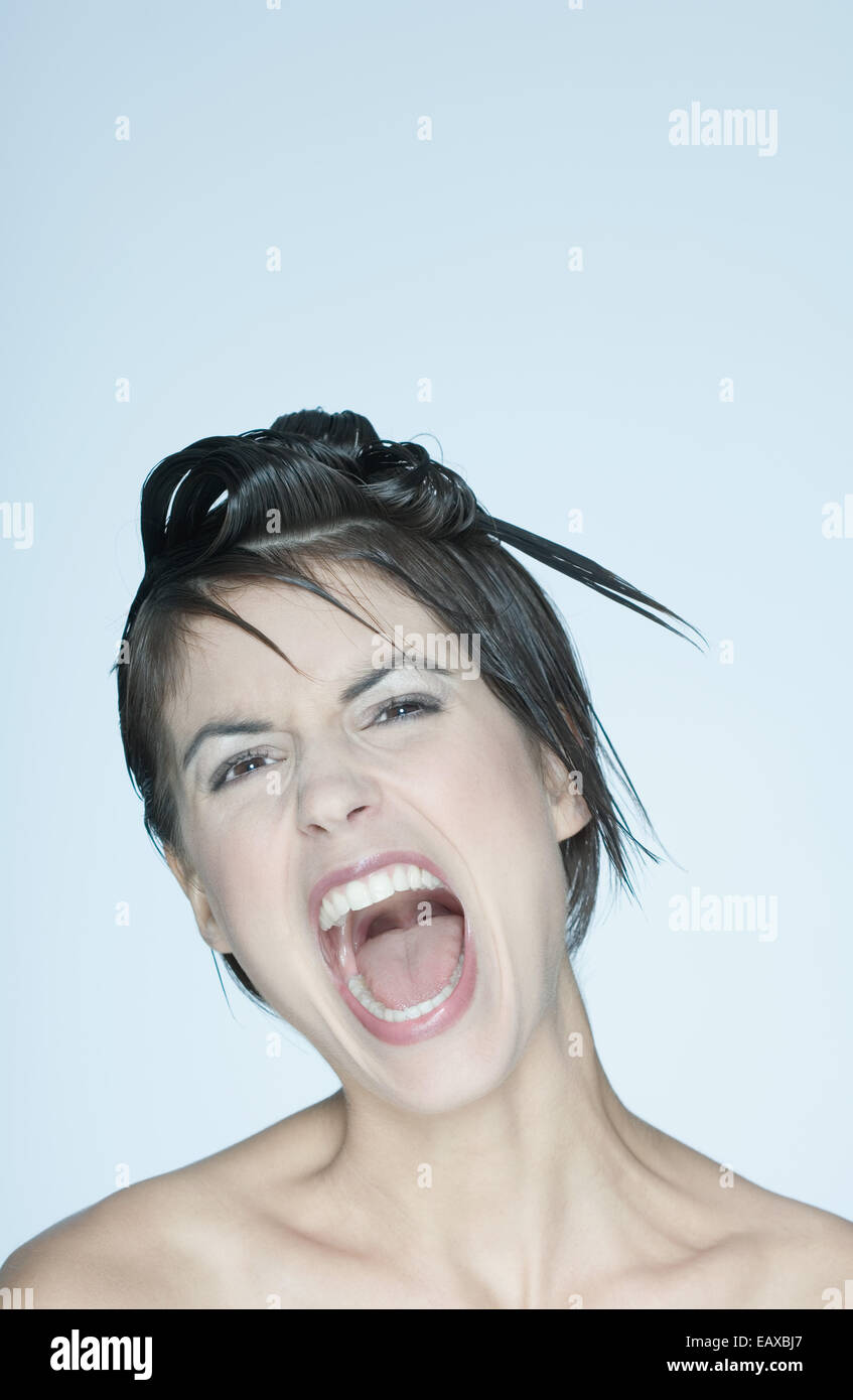 Woman with spiky hairstyle, mouth open, portrait Stock Photo - Alamy