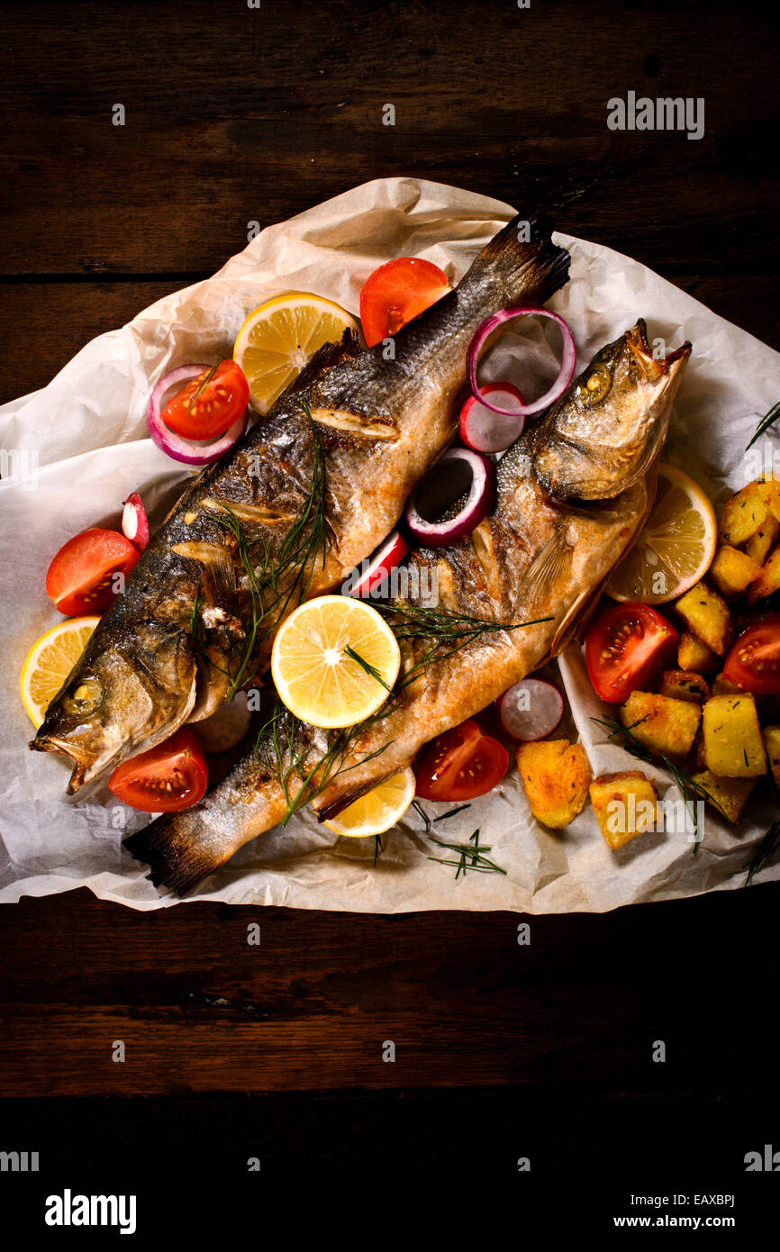 Prepared and grilled bas fish with potato and vegetables Stock Photo ...