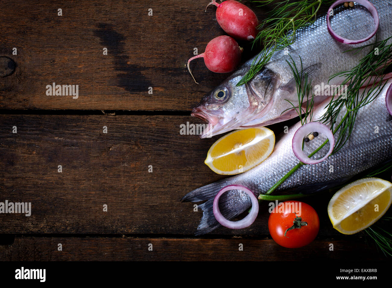 Fresh bass fish on the wooden background with blank space Stock Photo ...