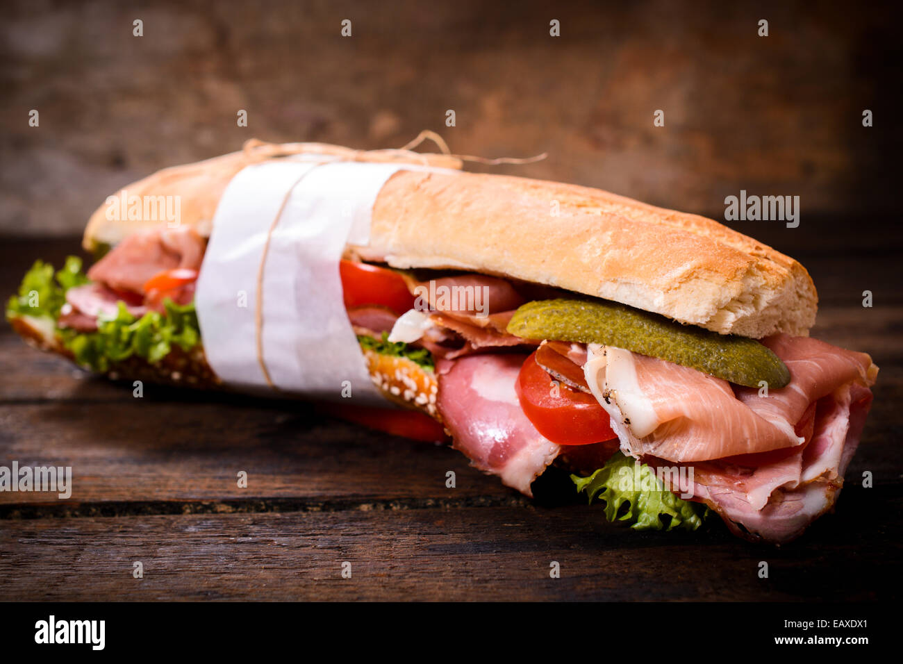 Long bun sandwich with prosciutto and vegetables,selective focus Stock ...