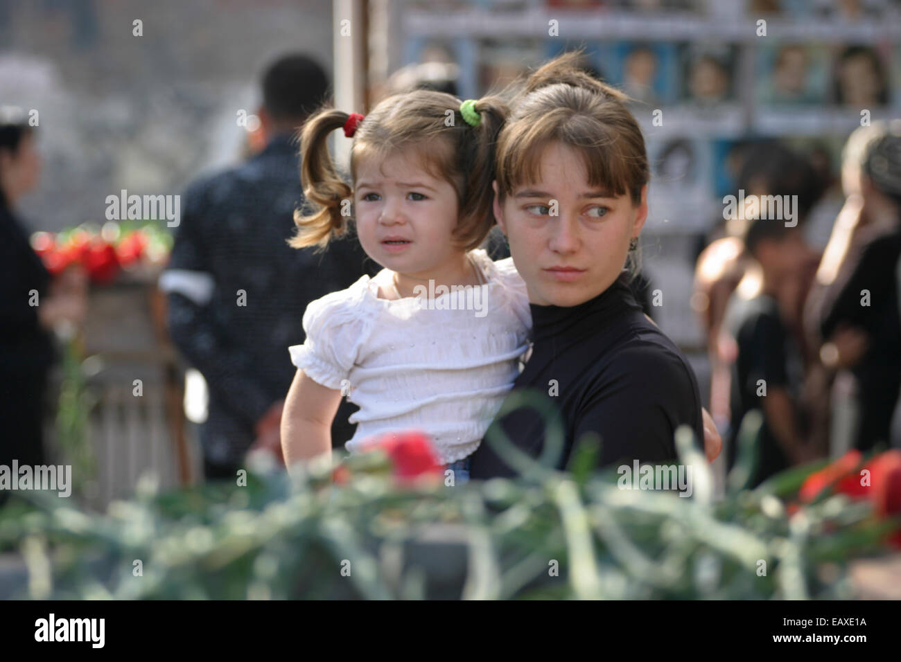 Woman with her daughter mourning the victims of a terrorist attack in ...