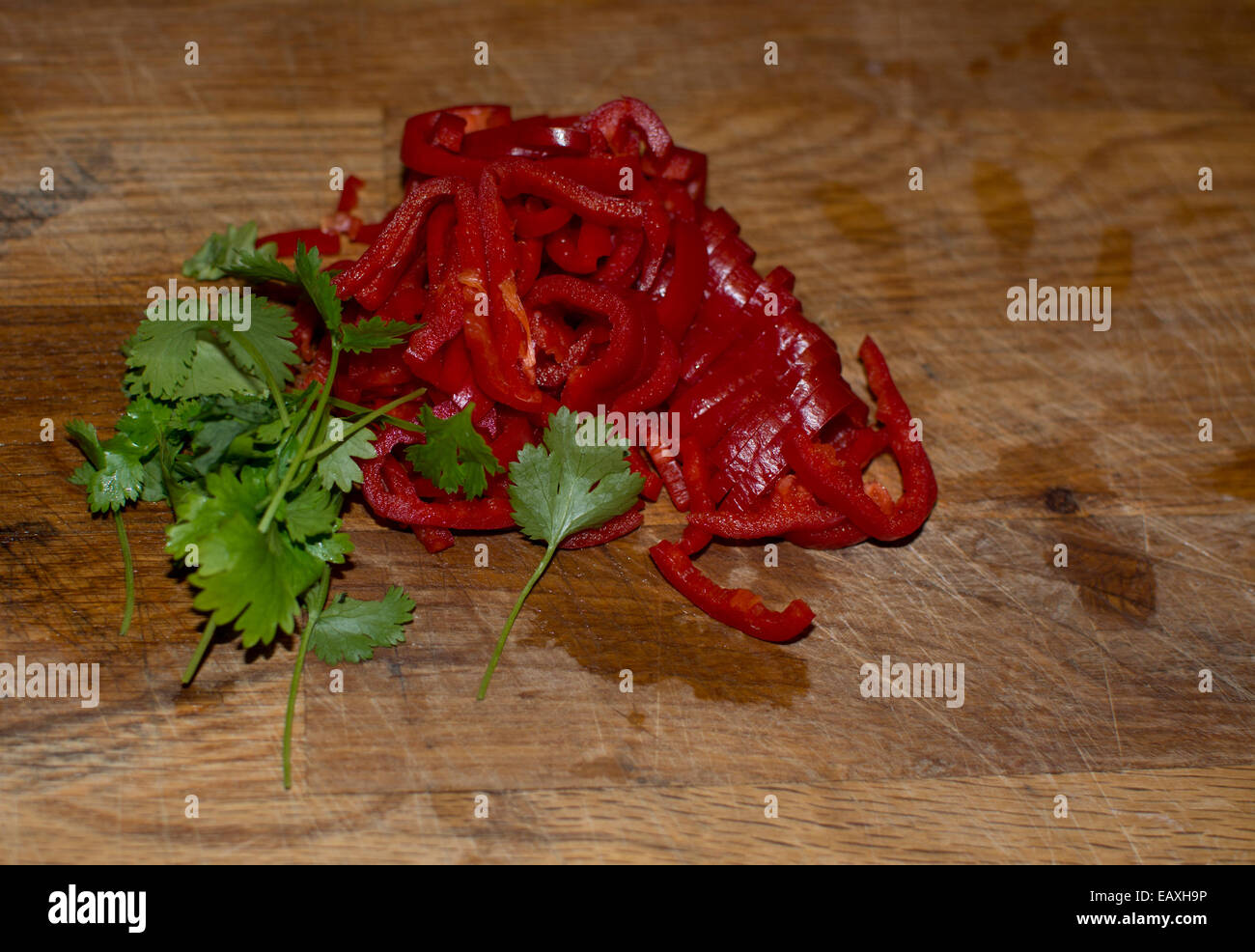Peppers and cilantro Peppers and cilantro to be prepared on a wood ...