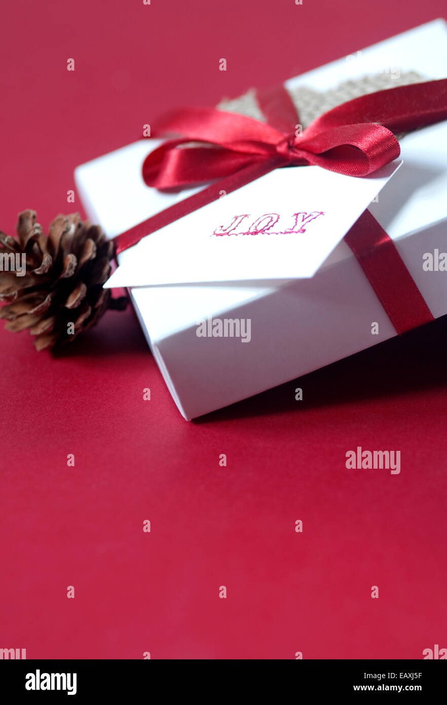 Still life concept image of white box gift wrapped with the word Joy ...