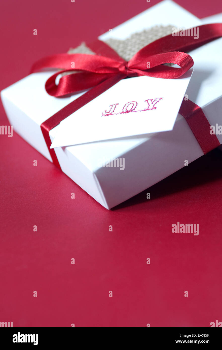 Still life concept image of white boxes gift wrapped with the word Joy ...