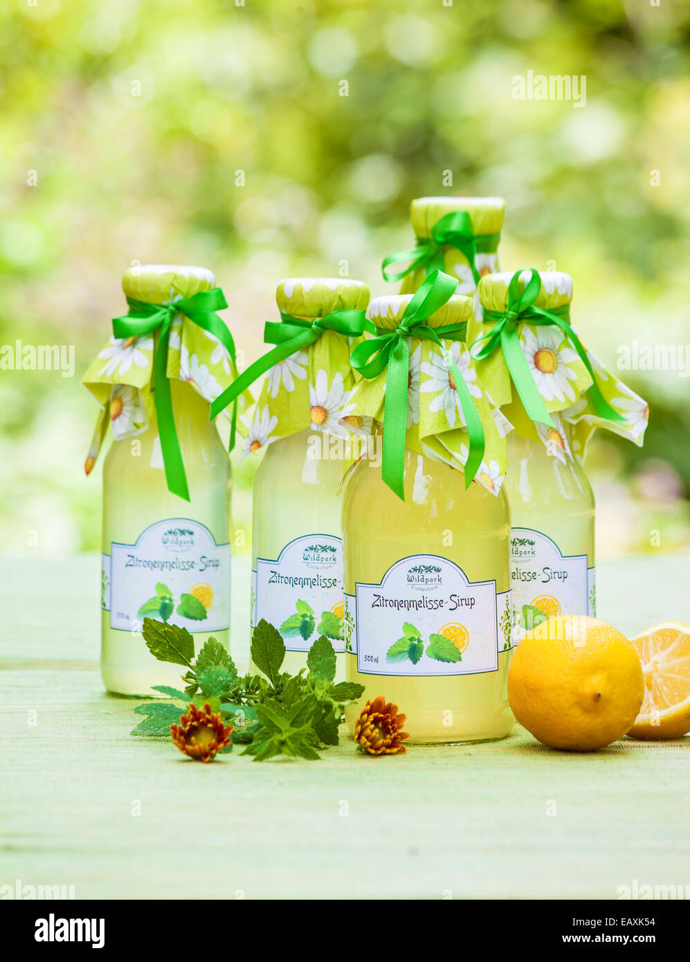 Bottles with lemon balm syrup in the garden Stock Photo - Alamy