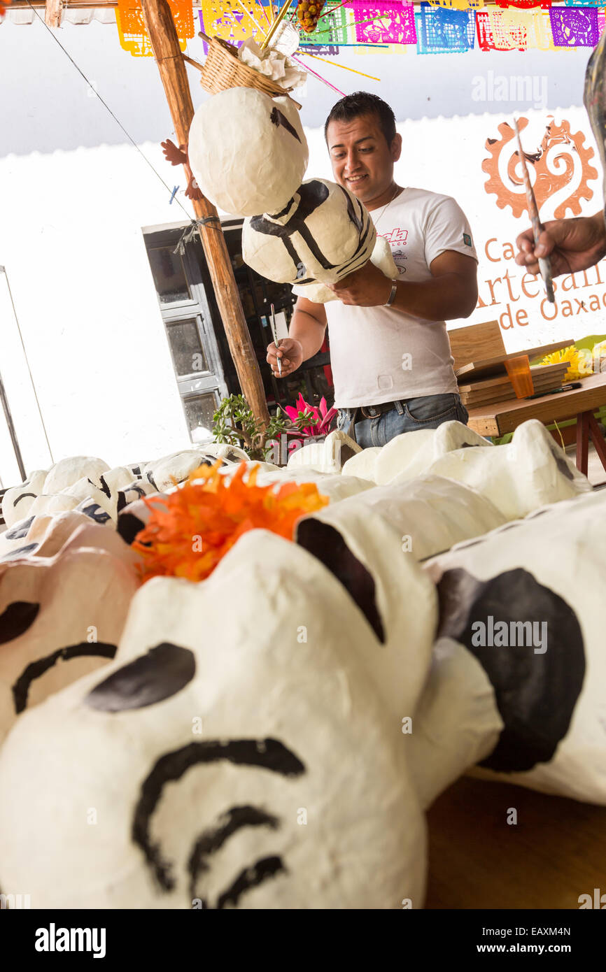 Artists work on skeleton decorations in preparation for the Day of the ...
