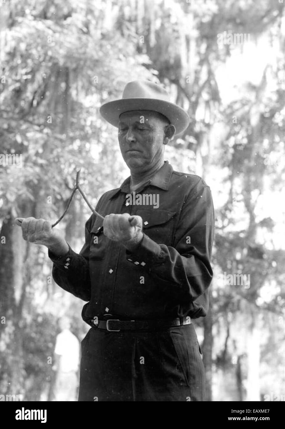 This photograph captures Lonnie Morgan, a water witcher, performing ...