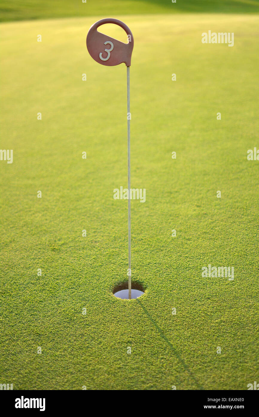Golf hole number 3 with a nice sunny blurred background Stock Photo - Alamy