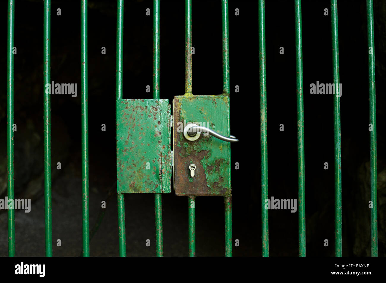 Cage door handle, protecting an entrance to a cave Stock Photo - Alamy