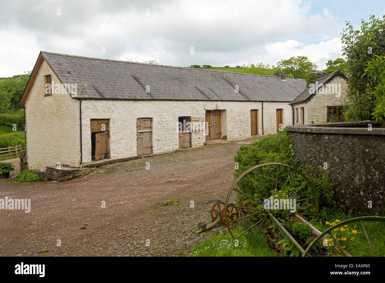 Extensive white painted stable buildings with red dirt track & clusters ...