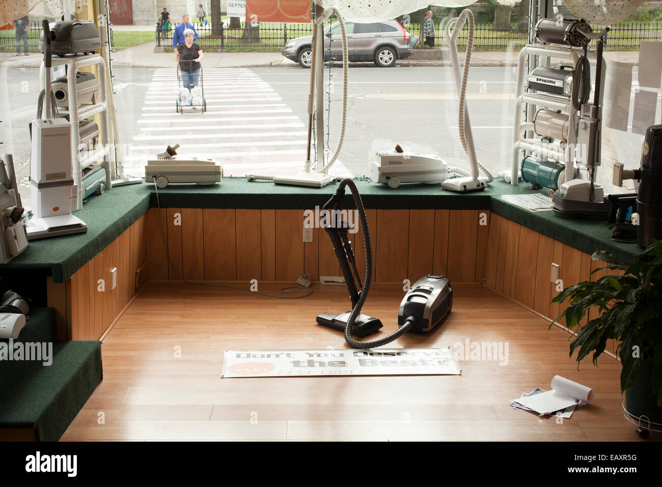 Storefront bay window of a vacuum cleaner shop has a street view of ...