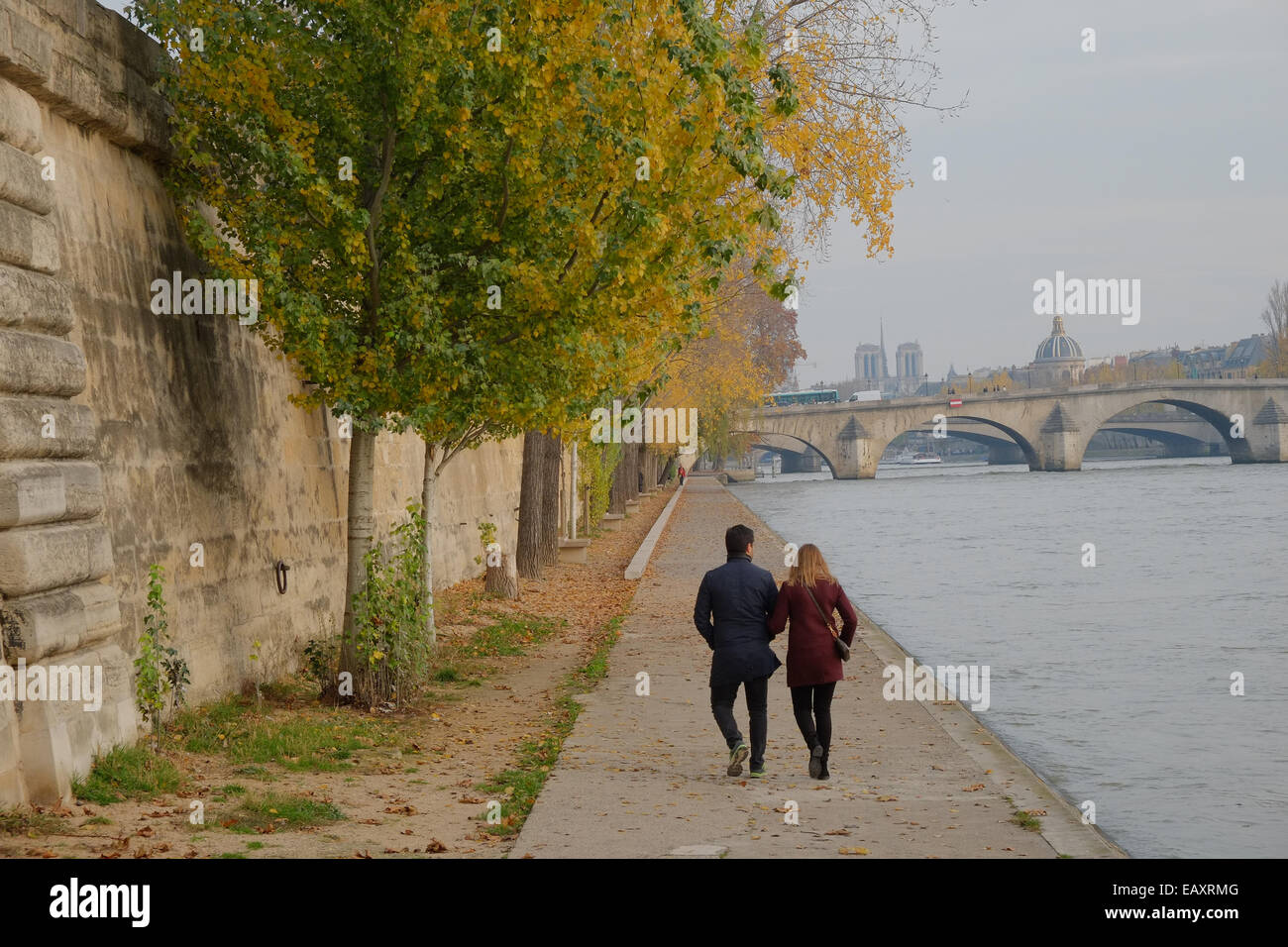 Paris, France. 21st Nov, 2014. Couple walking along side of River Seine ...
