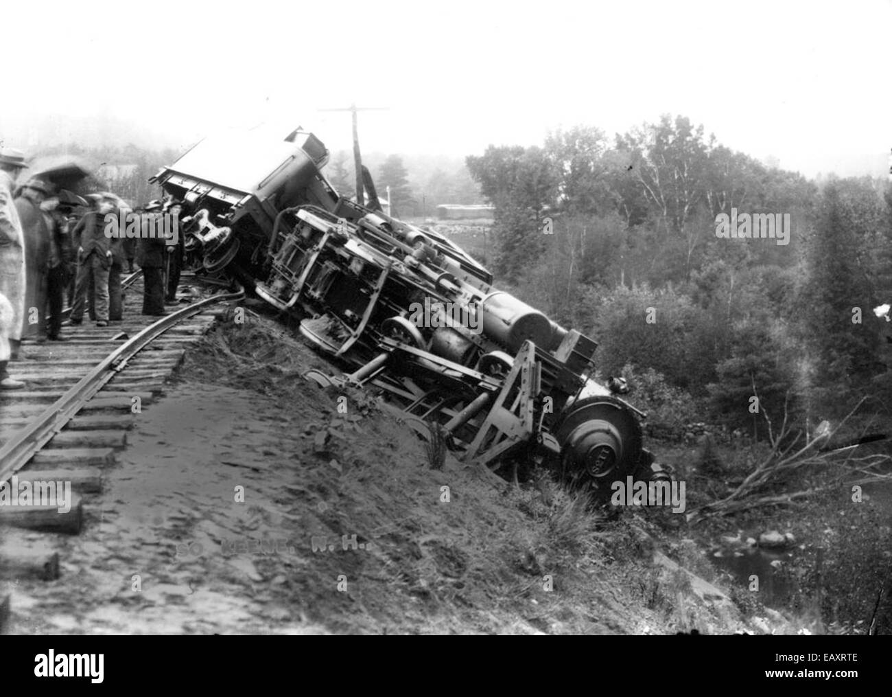 In this historical image, Boston & Maine train #1138 is shown derailed ...