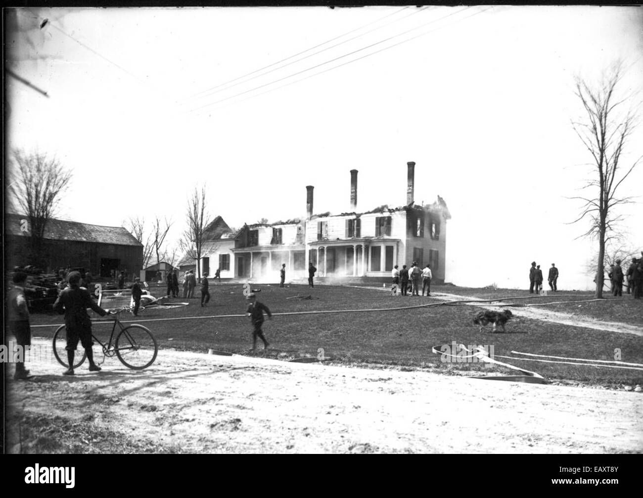 A fire at a three-chimneyed house in Keene, New Hampshire, is depicted ...