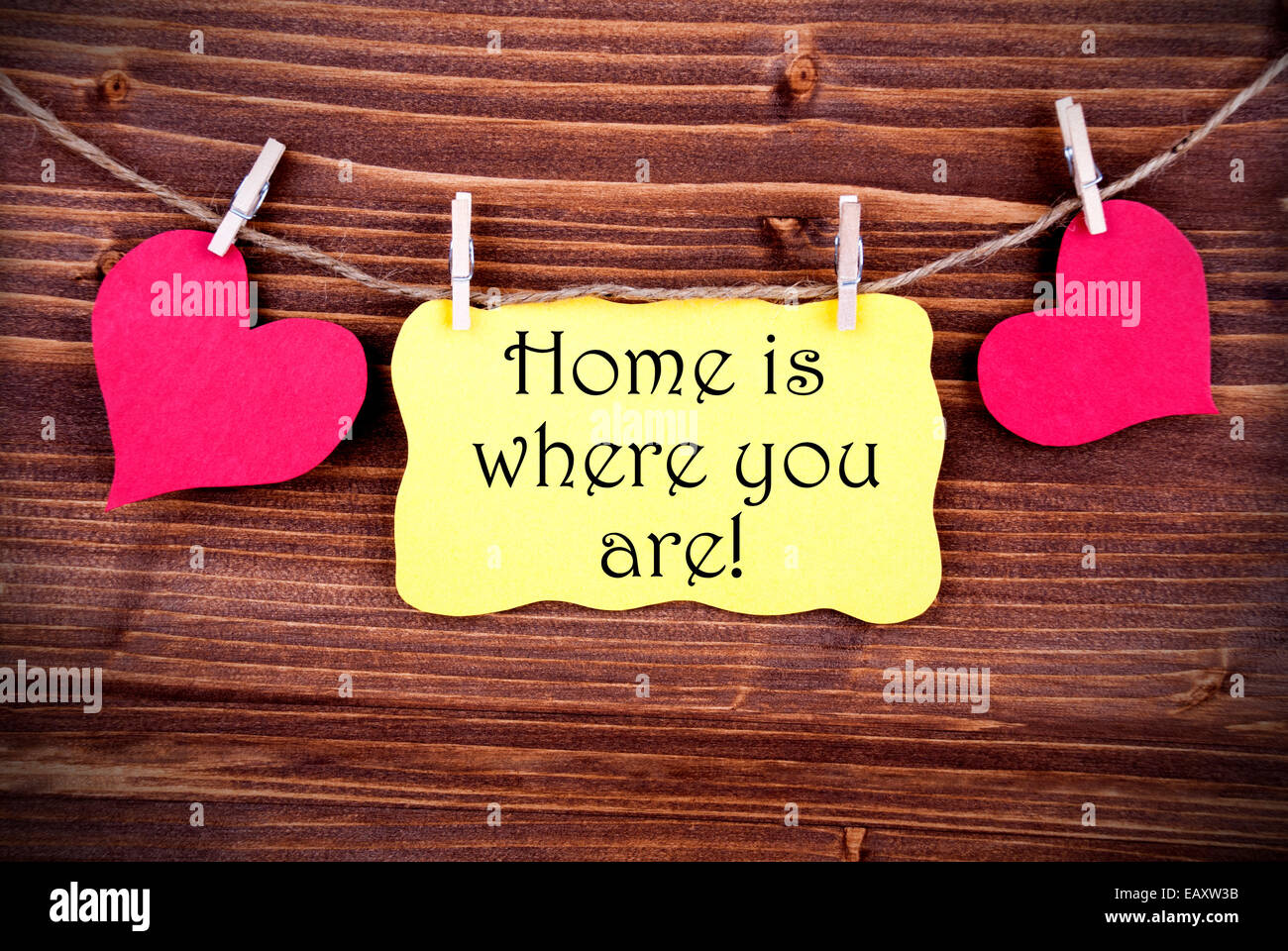 Yellow Lable Saying Home Is Where You Are On Wooden Background Hanging ...