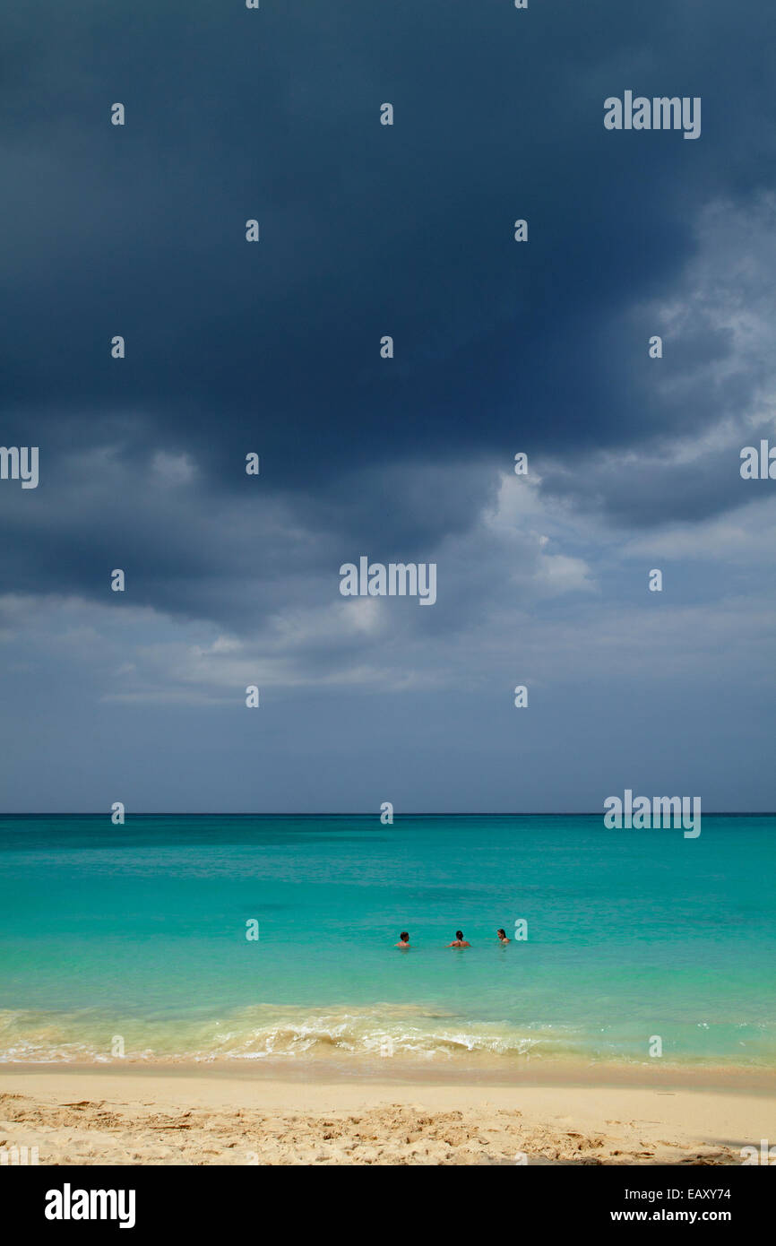 People swimming at Waimanalo Beach, and storm clouds, Oahu, Hawaii, USA ...