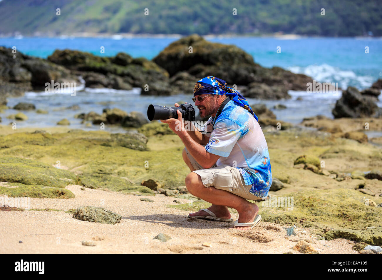 Male photographer with DSLR camera ready for action on the beach Stock ...