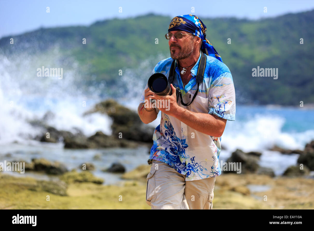 Male photographer with DSLR camera ready for action on the beach Stock ...