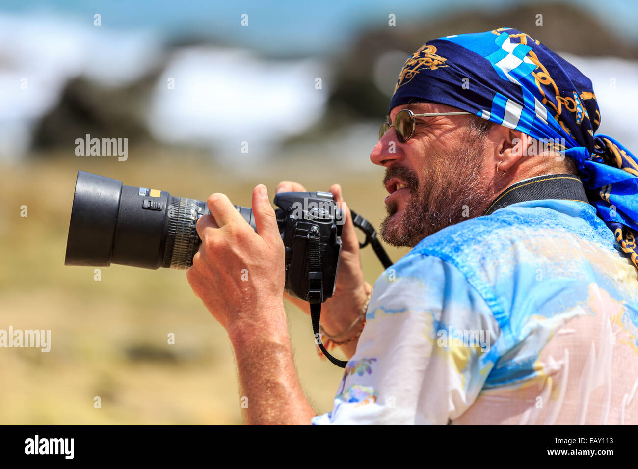 Male photographer with DSLR camera ready for action on the beach Stock ...