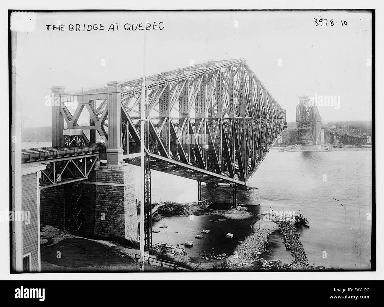 This historic image captures the bridge at Quebec, showcasing its ...