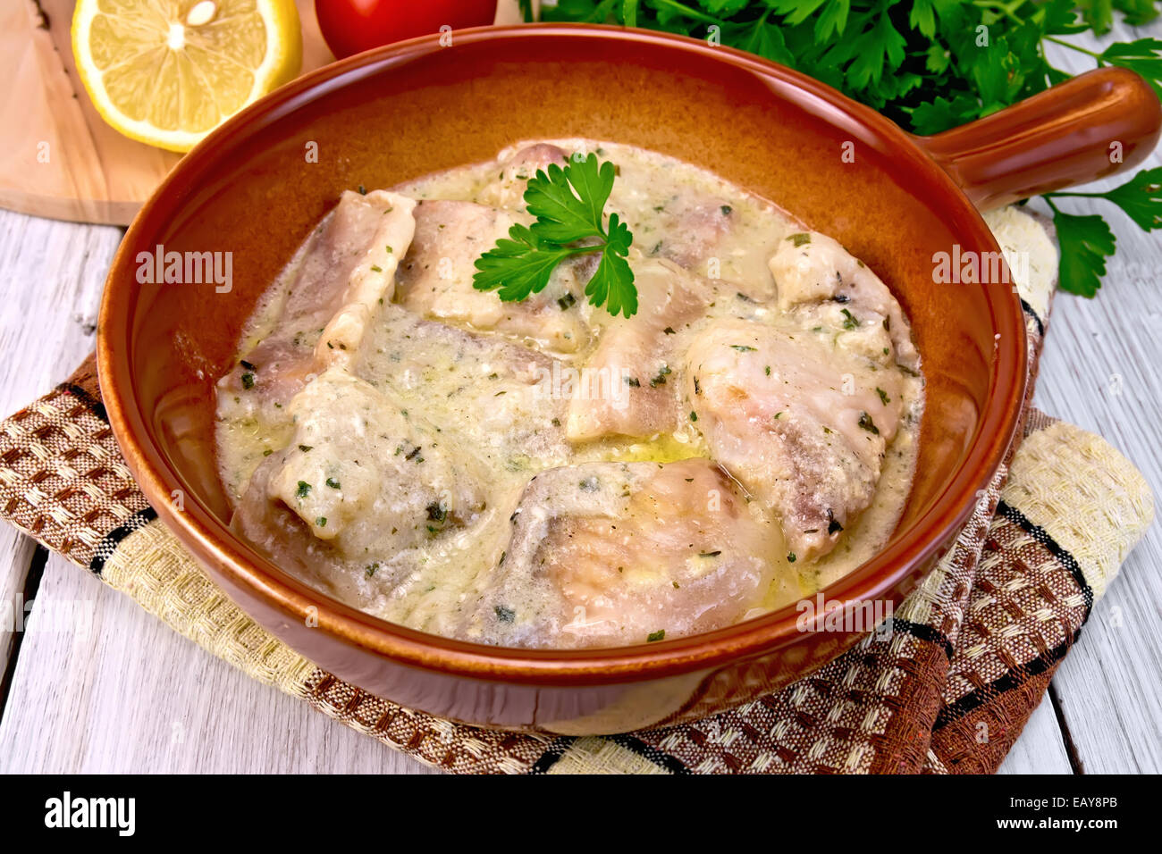 Fish stew in sauce on ceramic pan Stock Photo - Alamy