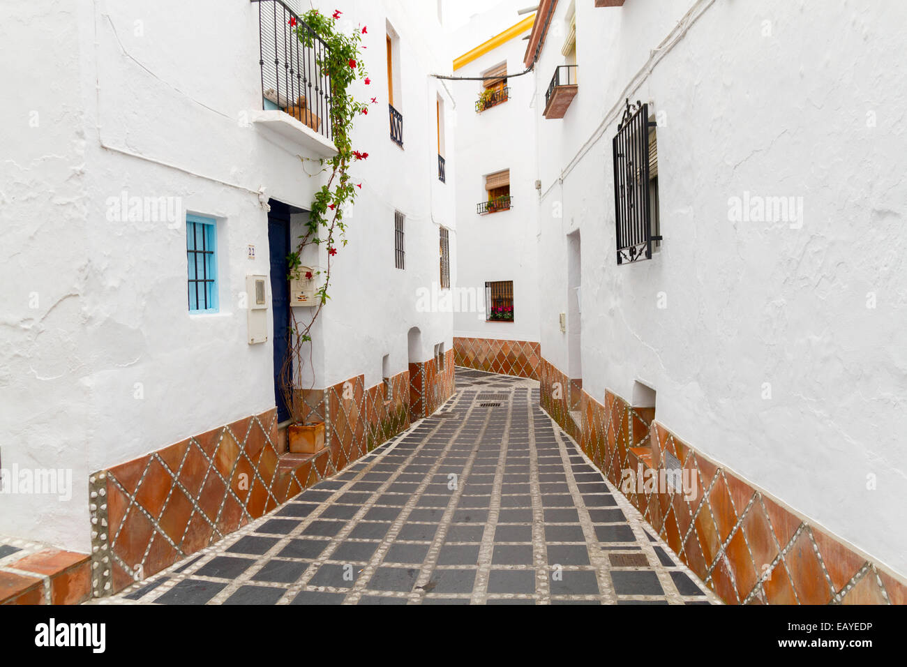 Tiled narrow streets in the Spanish white village of Competa on the ...