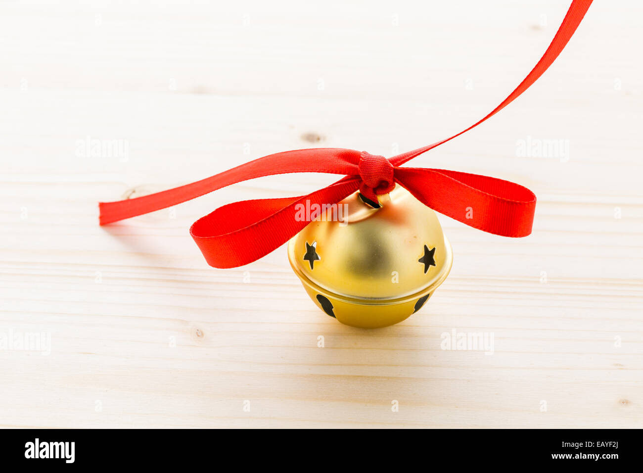 Multicolor jingle bells with red ribbon Stock Photo - Alamy