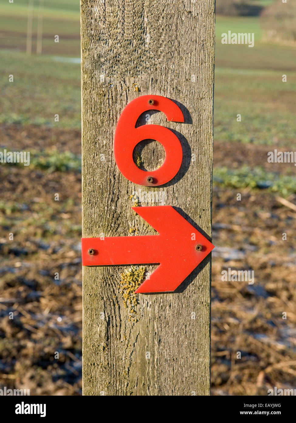 Red number 6 and red arrow on a post Stock Photo - Alamy