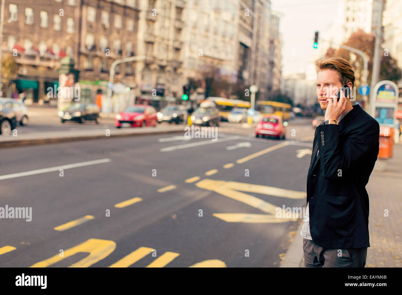 Young man on the street with mobile phone Stock Photo - Alamy