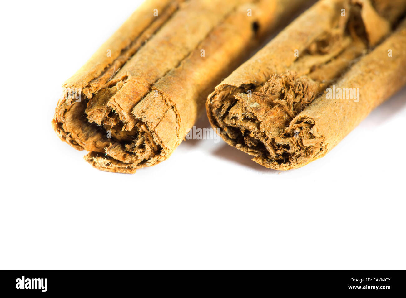 Cinammon sticks isolated on white Stock Photo - Alamy