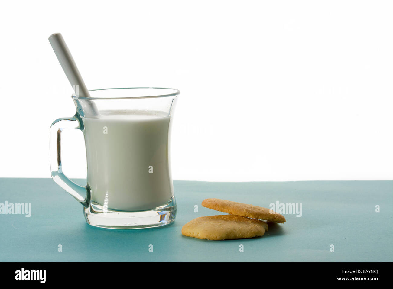 transparent mug of milk on blue background Stock Photo - Alamy