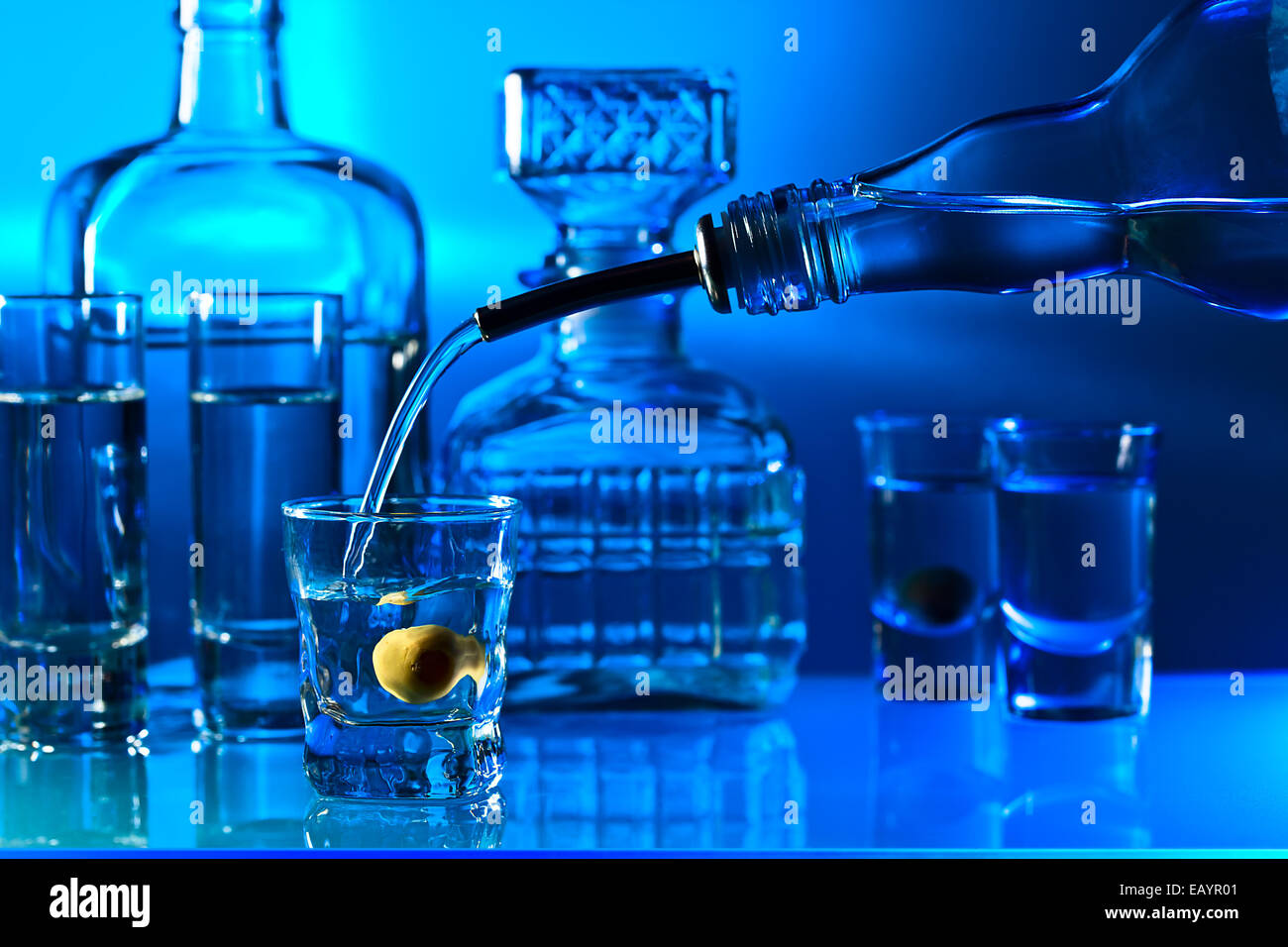 vodka and olive in bar on a glass table Stock Photo - Alamy