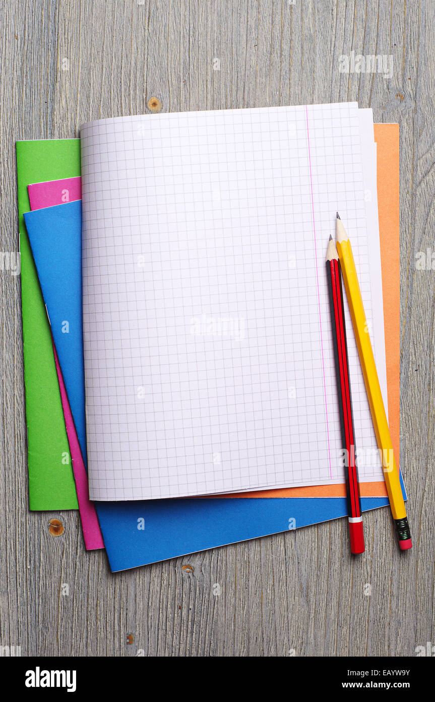 Opened school notebooks and pencils on the desk Stock Photo - Alamy