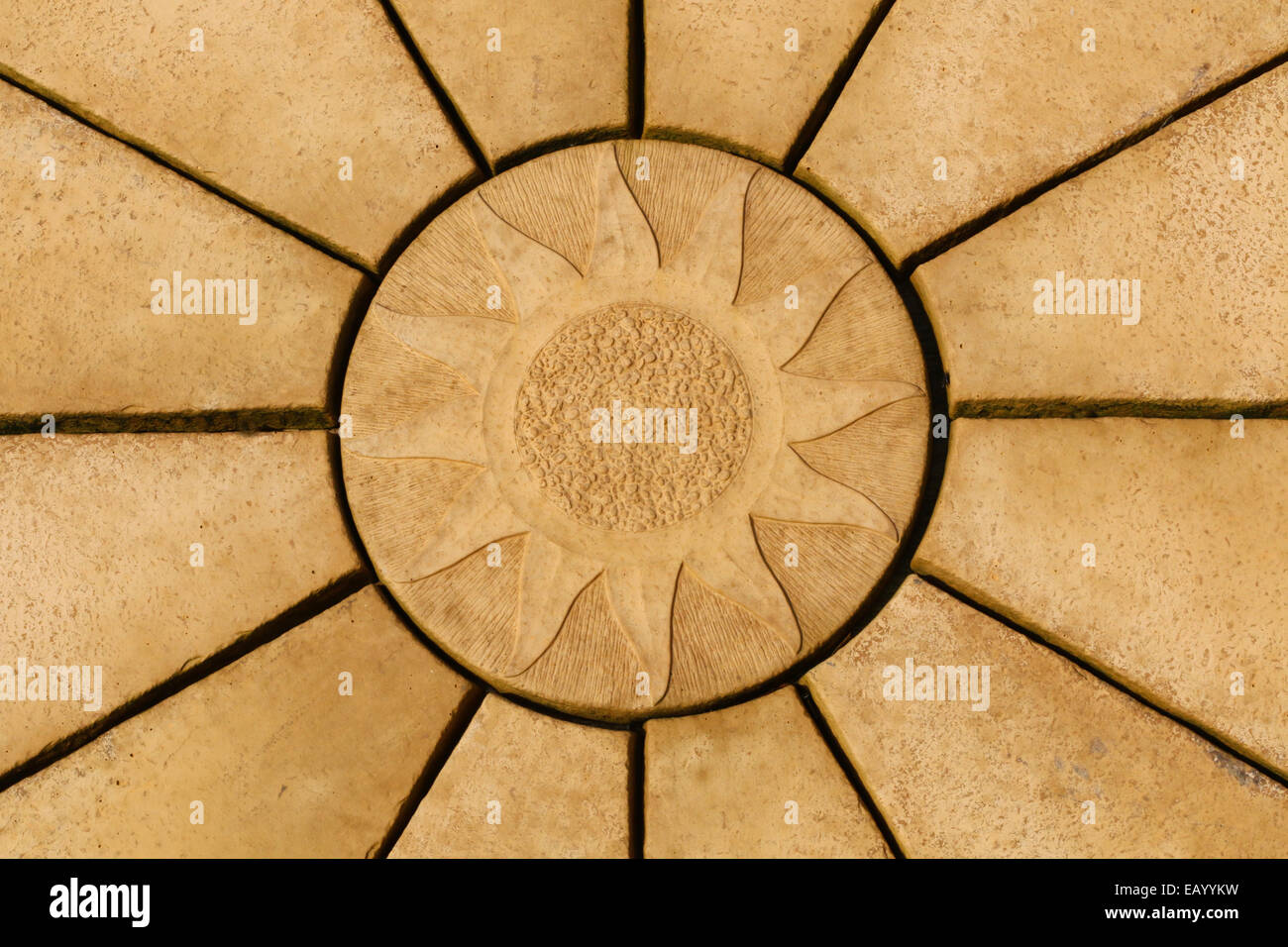 Sun design on golden coloured paving stone star pattern. Background or ...