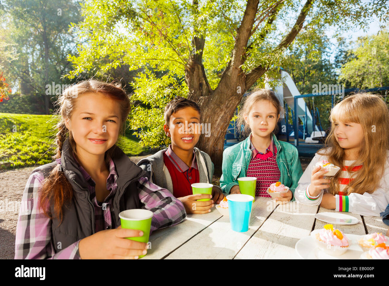 International children drink tea from cups outside Stock Photo - Alamy