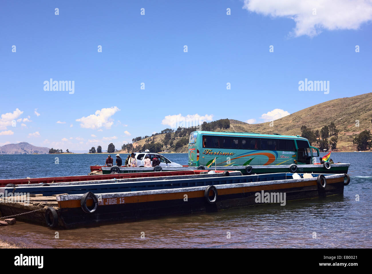 Bus and car on wooden motorized ferry on Lake Titicaca at the Strait of ...