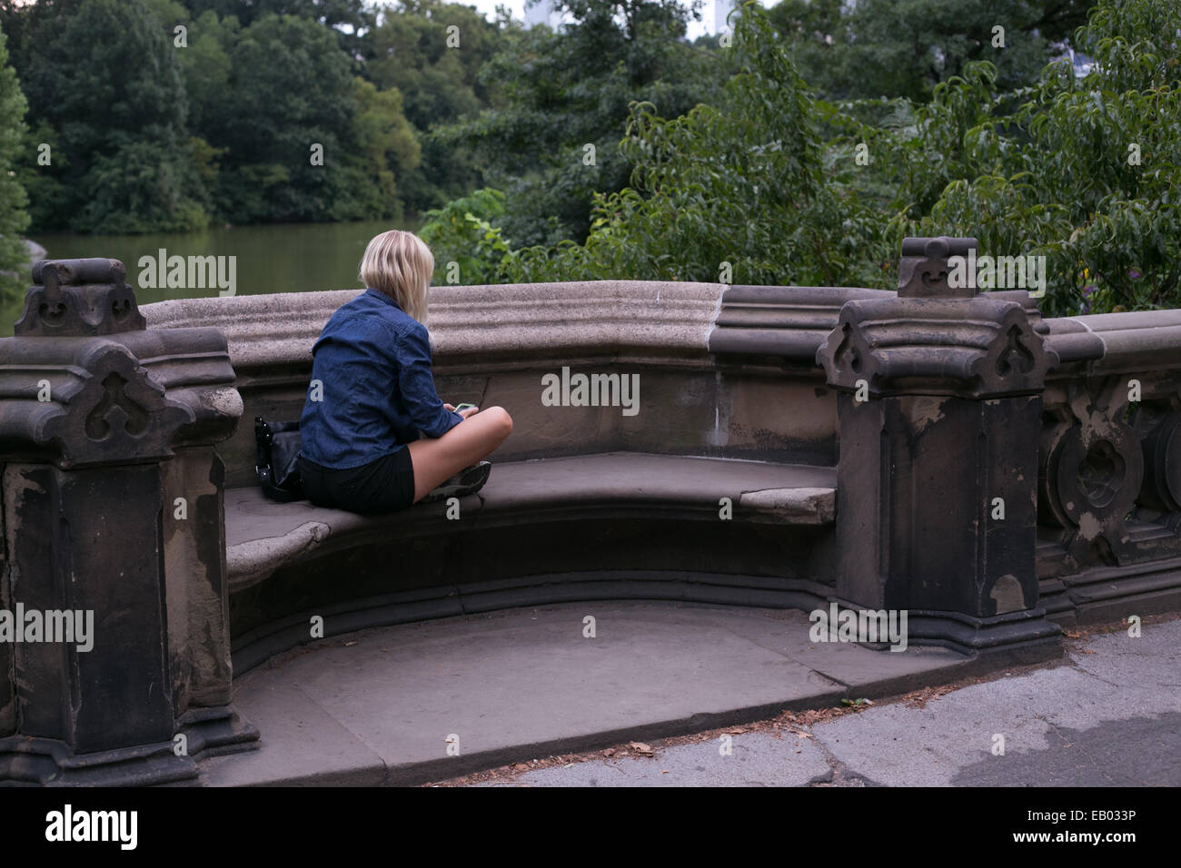 A woman sitting in one of the balcony's on Balcony Bridge in Central ...