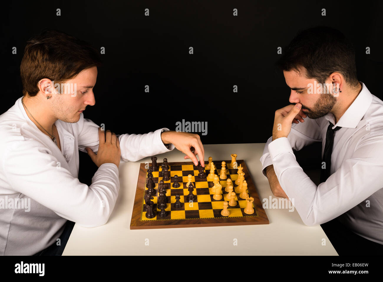 Two guys in their 20s concentrated playing chess Stock Photo - Alamy