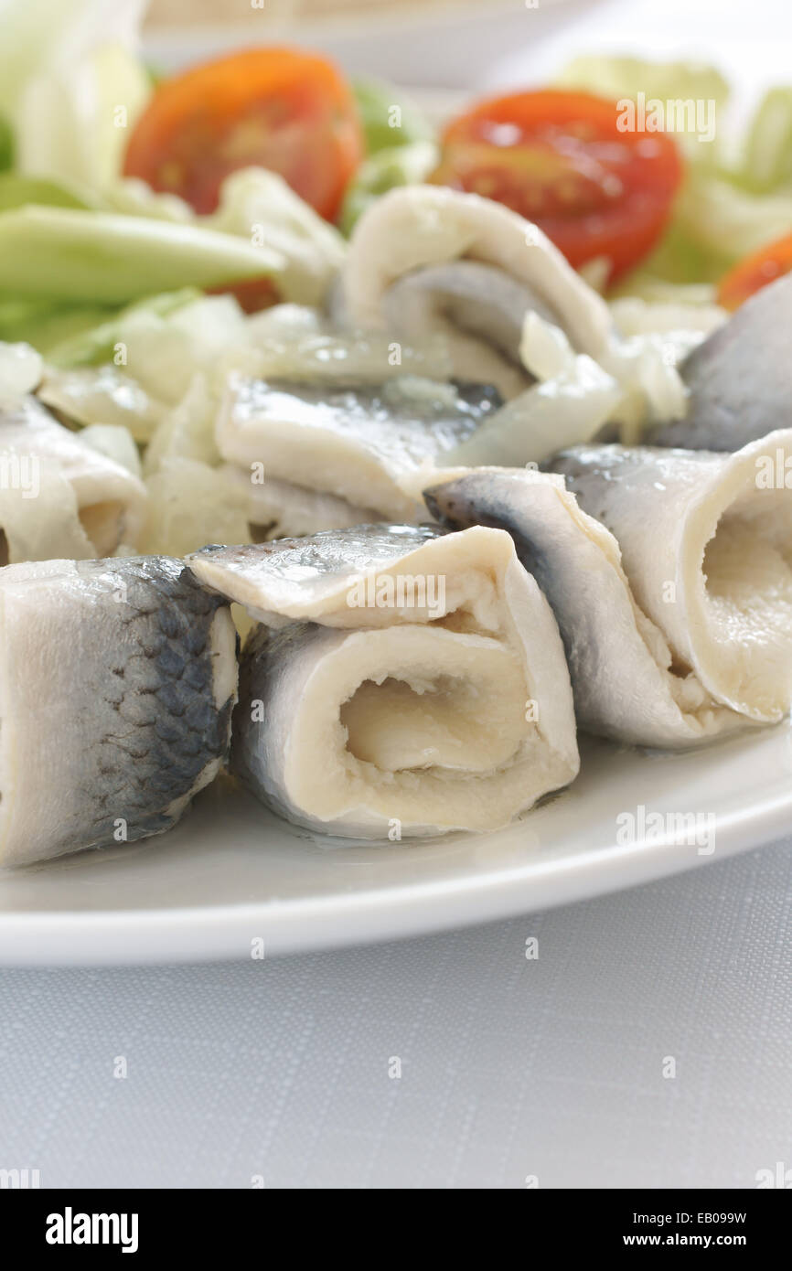 Rollmops or pickled herring fillets served with salad a popular seafood ...