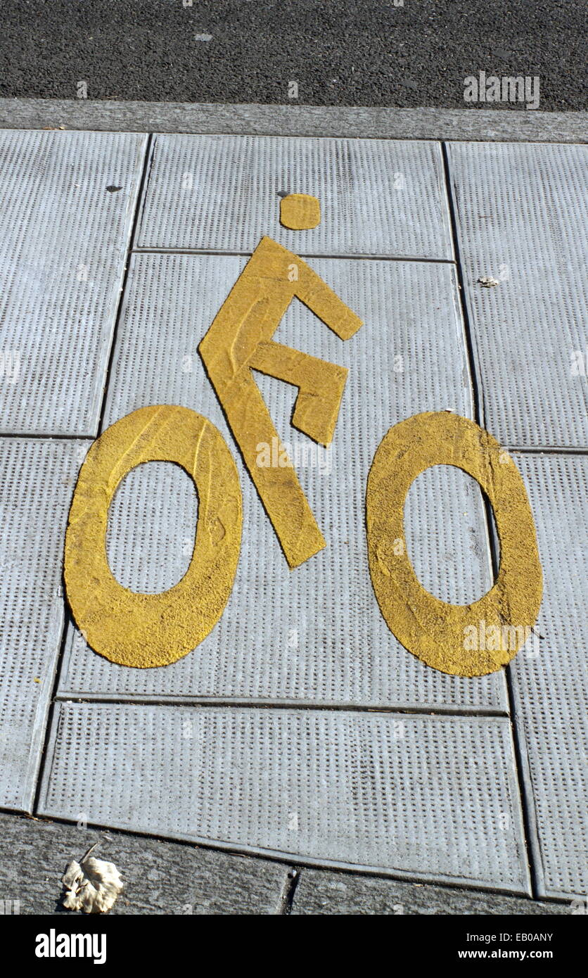 Yellow bicycle sign path on the pavement Stock Photo - Alamy